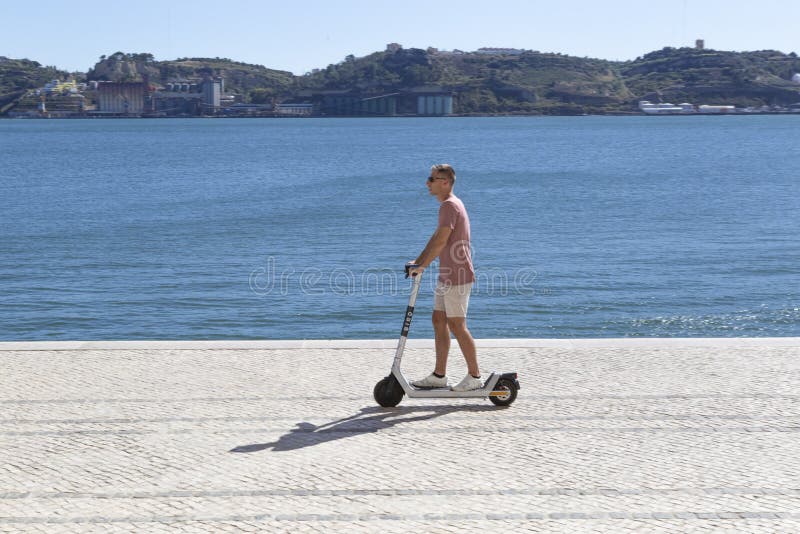 Person Riding a Scooter by the Tagus River Editorial Image - Image of ...