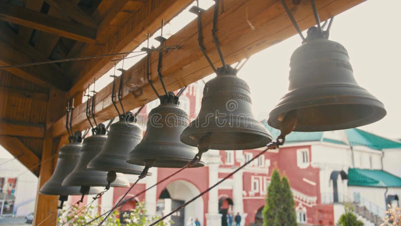 A Person Rings the Several Bells Pulling by Ropes Stock Footage - Video ...