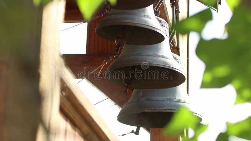 A Person Rings the Several Bells Pulling by Ropes Stock Footage - Video ...
