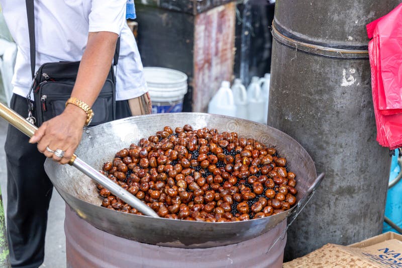 A Person Roasting Chestnuts on the Street Stock Image - Image of ...