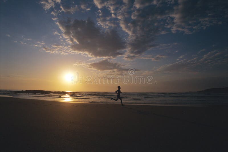 Person Running Along Beach at Sunset Stock Photo - Image of fitness ...