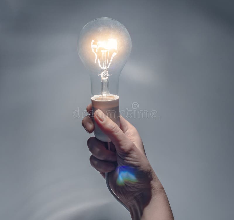 A Person S Hand Holds a Lamp. Blackout, Lighting Technologies. New Idea ...