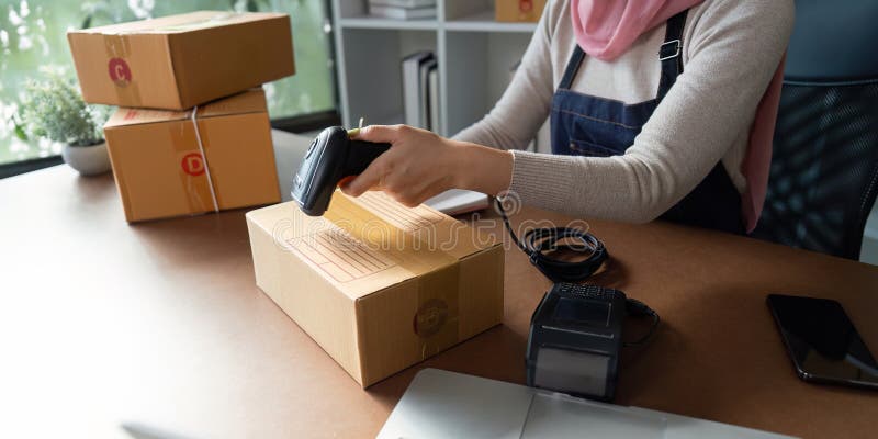 Using a Barcode Scanner on a Package for Shipping Preparation Stock ...
