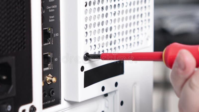 Close-up of Hand Using Screwdriver To Tighten on White PC Case Near ...