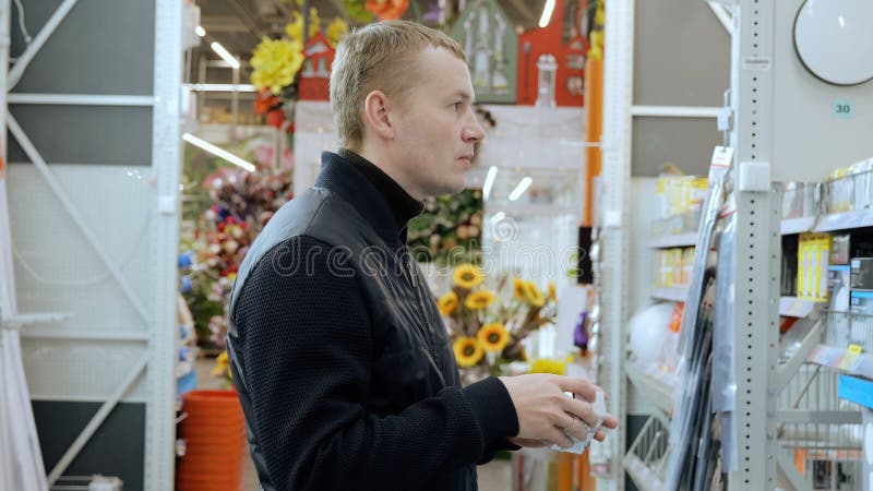 Person Selecting a Light Bulb from a Selection of Different Options on ...