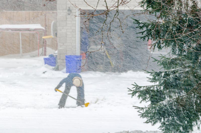 Person Shoveling during a Snowstorm Stock Photo - Image of shoveling ...
