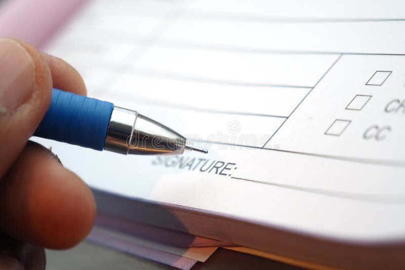 Person Signing a Document with a Blue Pen on a White Page Stock Photo ...