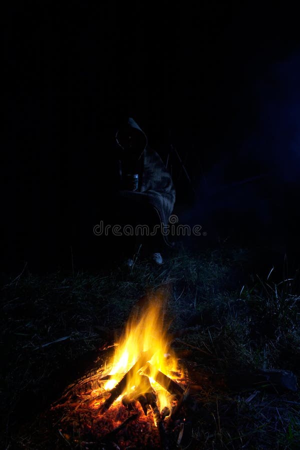 Person Sitting Near of a Fire Stock Image - Image of picnic, bonfire ...