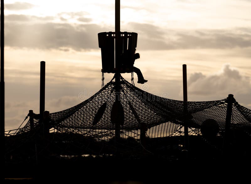 Person Sitting in a Playground Climbing Net.. Stock Image - Image of ...