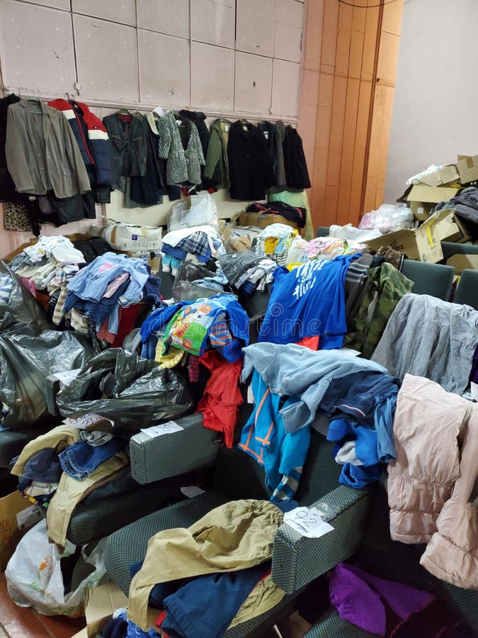 Person Sorting Second Hand Clothes by Size and Gender Stock Photo ...