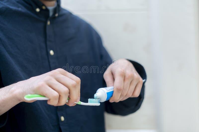 A Person Squeeze Toothpaste on a Toothbrush in Bathroom Stock Photo ...
