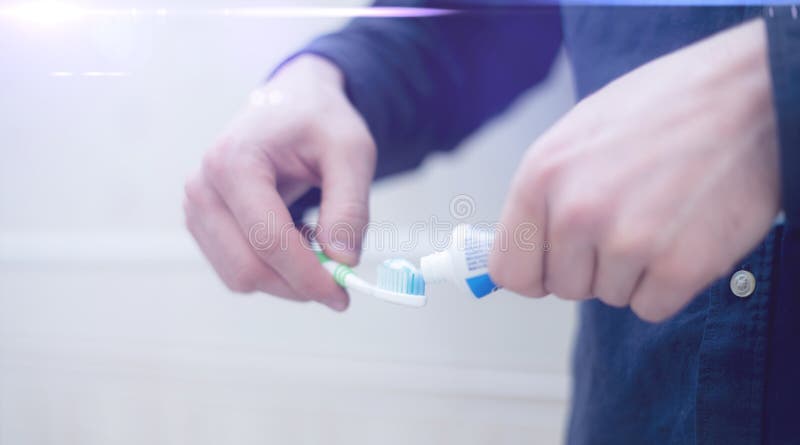 A Person Squeeze Toothpaste on a Toothbrush in Bathroom Stock Photo ...