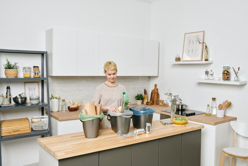 A Person Standing by Kitchen Table while Sorting Waste Stock Image ...