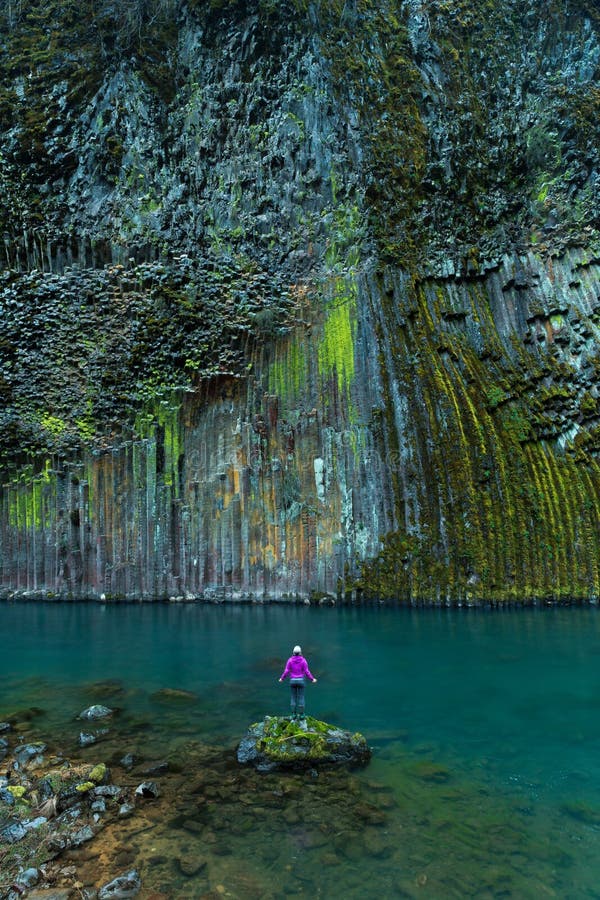 Person Standing on a Rock in Front of a Waterfall Stock Photo - Image ...