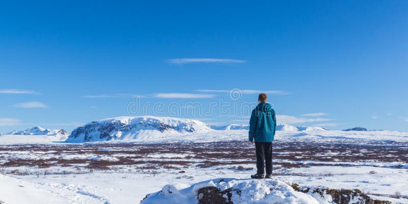 Person Standing on a Rock and Looking at Ice Under the Sunlight in ...