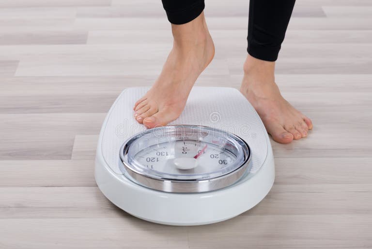 Person Standing on Weighing Scale Stock Photo - Image of weighing ...