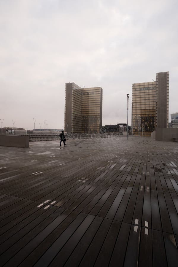 Person Strolling on a Deck with Modern Buildings in View Editorial ...