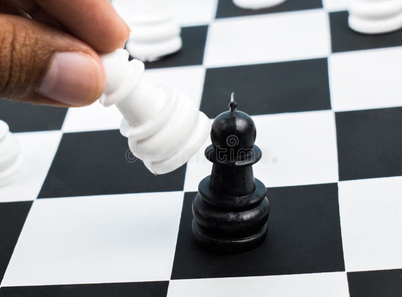 A Person Taking a Black Pawn with His Own White Pawn in a Normal Chess ...