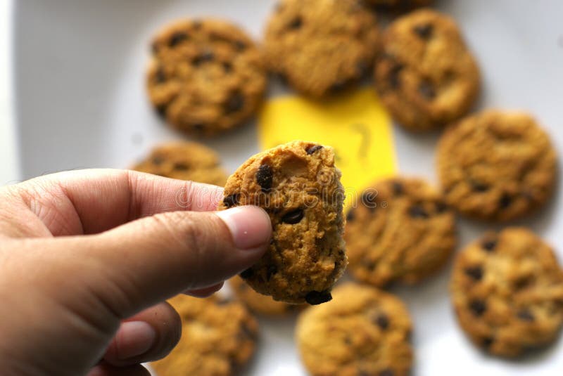 A Person Taking a Choco Chip Cookie from the Plate Stock Image - Image ...