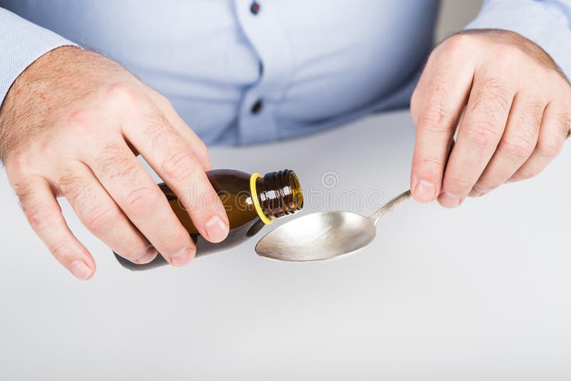 The Person Taking Cough Syrup. Stock Image - Image of glass, hand: 85576633