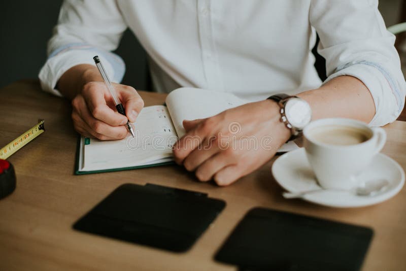 Person Taking Notes in a Notebook while Working from Home Stock Image ...