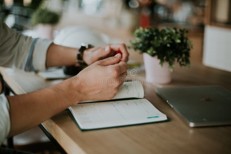 Person Taking Notes in a Notebook while Working from Home Stock Photo ...