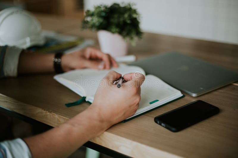 Person Taking Notes in a Notebook while Working from Home Stock Photo ...