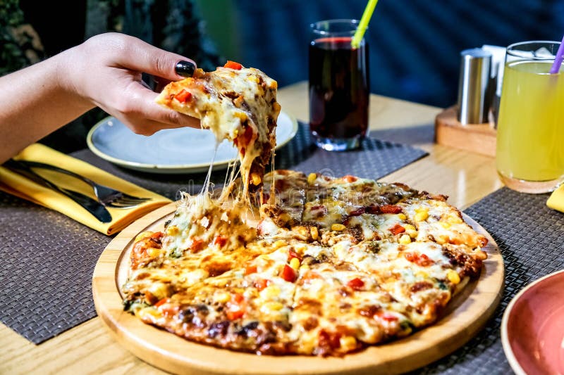 Person Taking a Slice of Pizza from a Table Stock Image - Image of ...