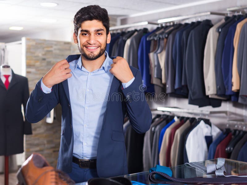 Person is trying on jacket stock photo. Image of decision - 214368658