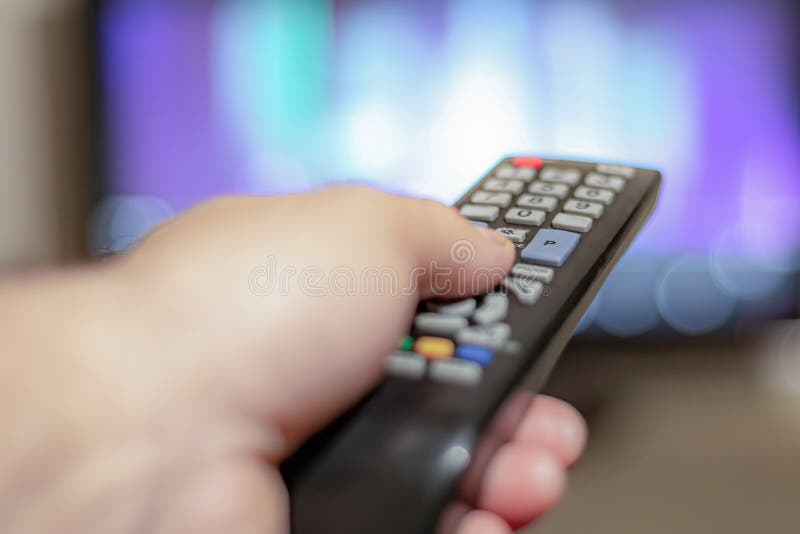 A Person with a TV Remote Controls the Remote Control To Switch ...