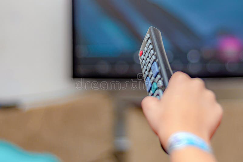 A Person with a TV Remote Controls the Remote Control To Switch ...