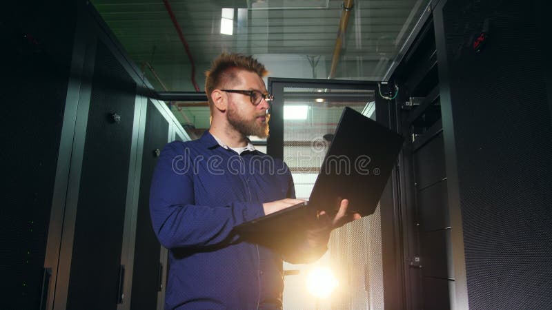 Server Room with a Robot Being Set by an Engineer with a Computer Stock ...