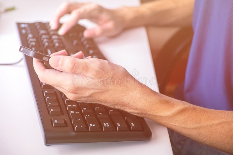 Person Typing on Keyboard and Using Smartphone Stock Image - Image of ...