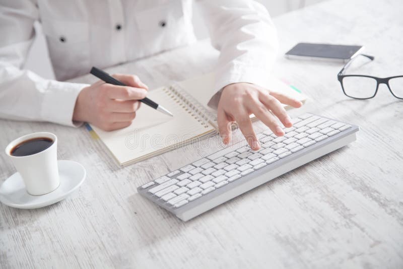 Person Typing in Keyboard and Writing on Notepad Stock Image - Image of ...