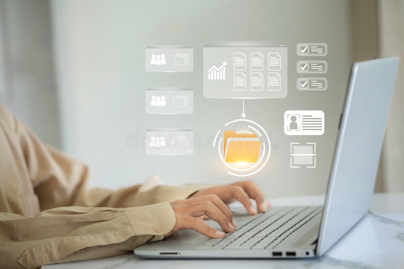 A Person is Typing on a Laptop with a Screen Showing a File Folder. the ...