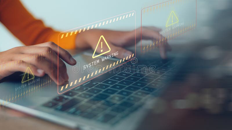 A Person is Typing on a Laptop with a Warning Sign on the Screen Stock ...