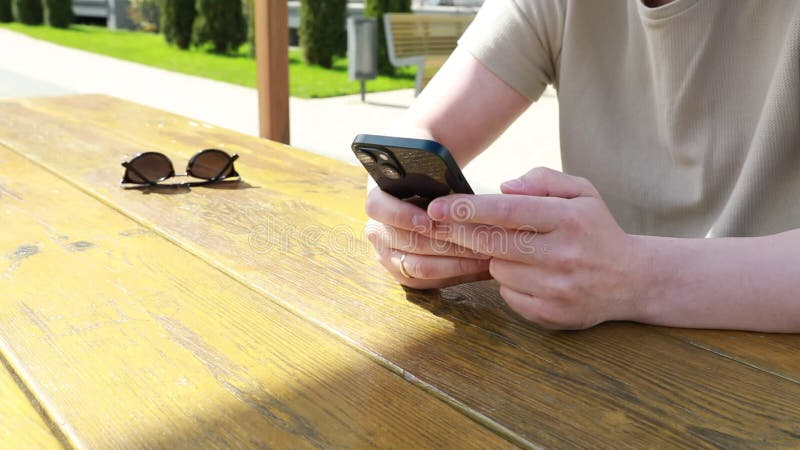 Person Using Cell Phone at Table Stock Video - Video of screen ...