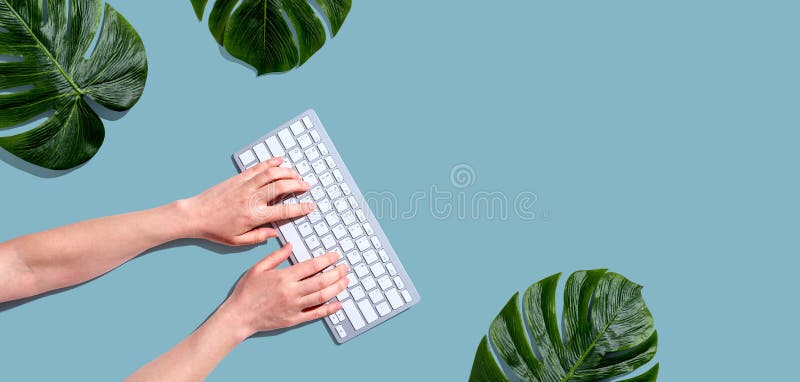 Person Using a Computer Keyboard with Tropical Leaves Stock Image ...