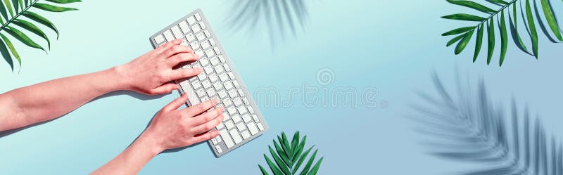 Person Using a Computer Keyboard with Tropical Leaves Stock Image ...