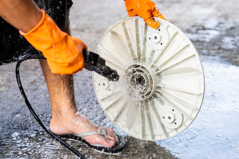 Person Using a High-pressure Hose is Rinsing the Base of the Automatic ...