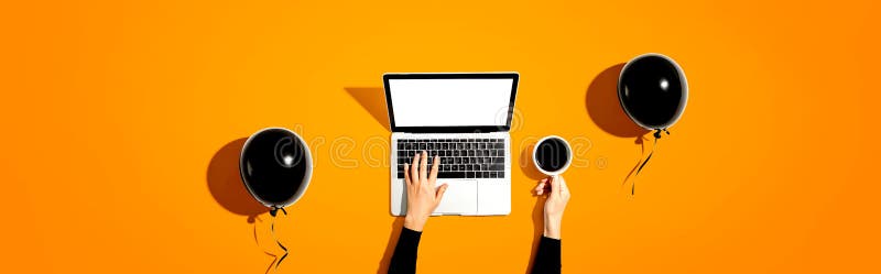 Person Using a Laptop Computer with Black Balloons Stock Photo - Image ...