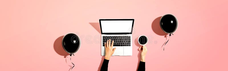Person Using a Laptop Computer with Black Balloons Stock Image - Image ...