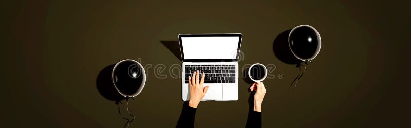 Person Using a Laptop Computer with Black Balloons Stock Photo - Image ...