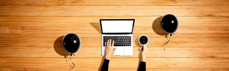 Person Using a Laptop Computer with Black Balloons Stock Image - Image ...