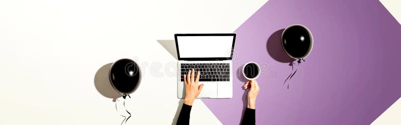 Person Using a Laptop Computer with Black Balloons Stock Photo - Image ...