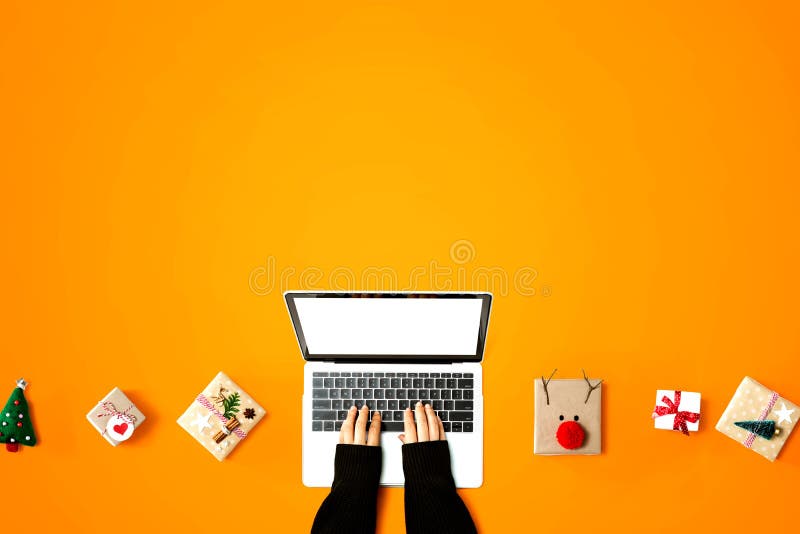 Person Using a Laptop Computer with Christmas Gift Boxes Stock Photo ...