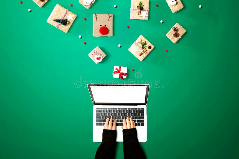 Person Using a Laptop Computer with Christmas Gift Boxes Stock Photo ...
