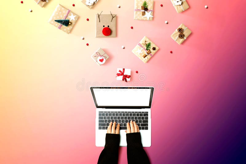 Person Using a Laptop Computer with Christmas Gift Boxes Stock Image ...
