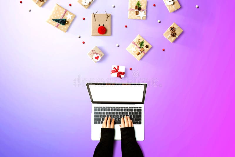 Person Using a Laptop Computer with Christmas Gift Boxes Stock Image ...