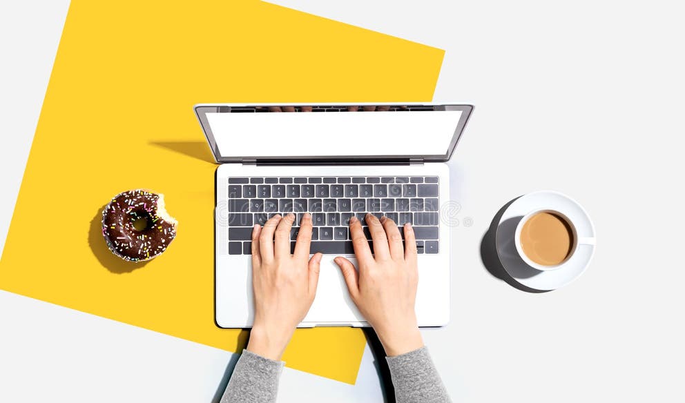 Person Using a Laptop Computer with a Donut and a Cup of Coffee Stock ...